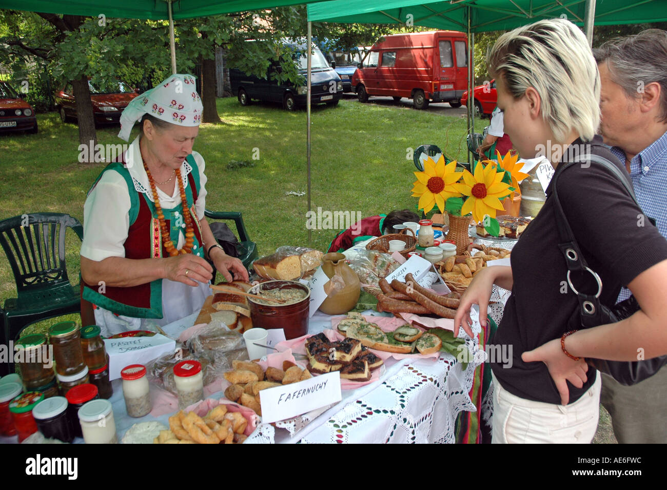 Woman in traditional polish Kurpie polish region costume selling her ...