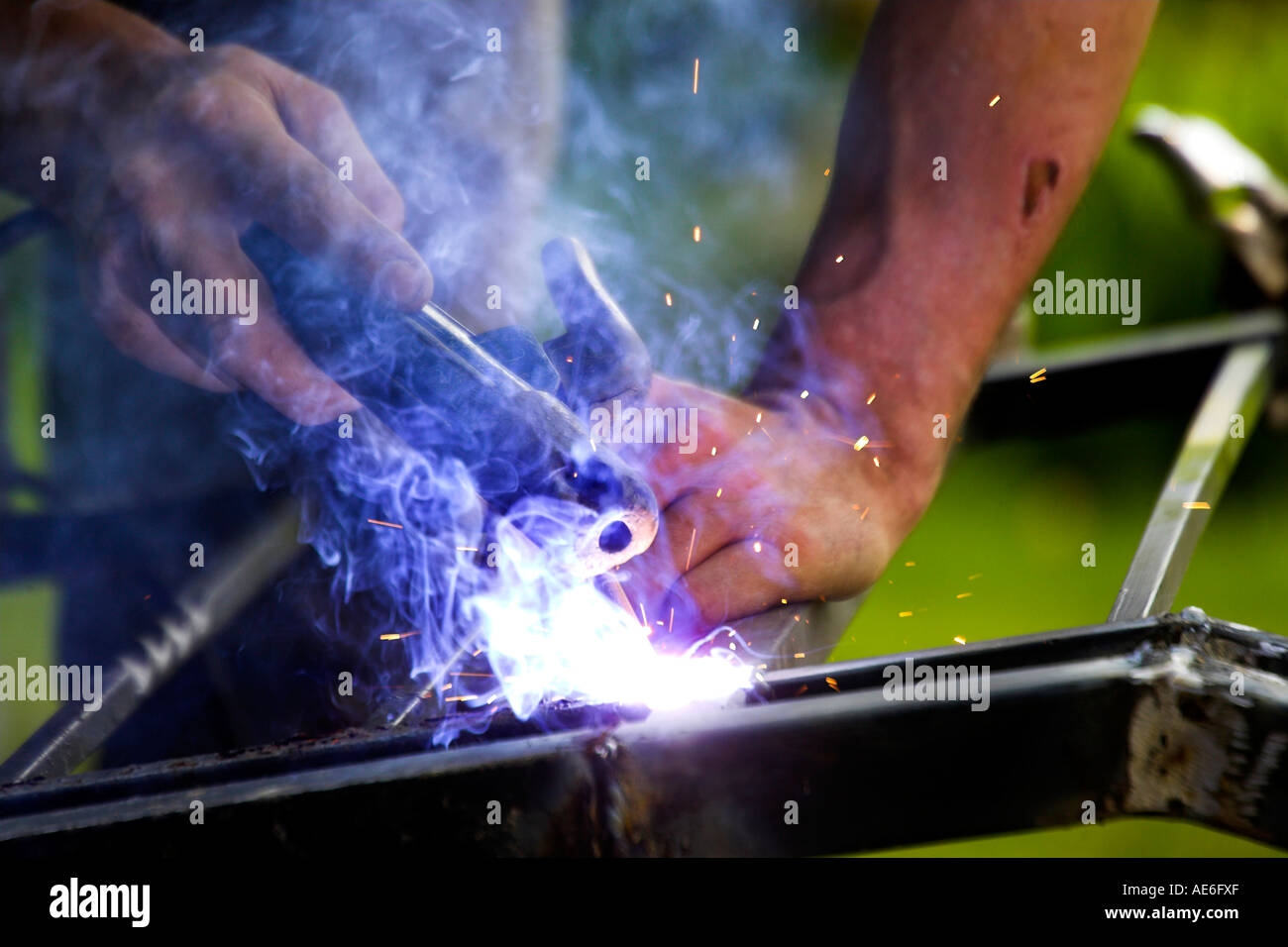 blacksmith welding wrought iron work Stock Photo - Alamy