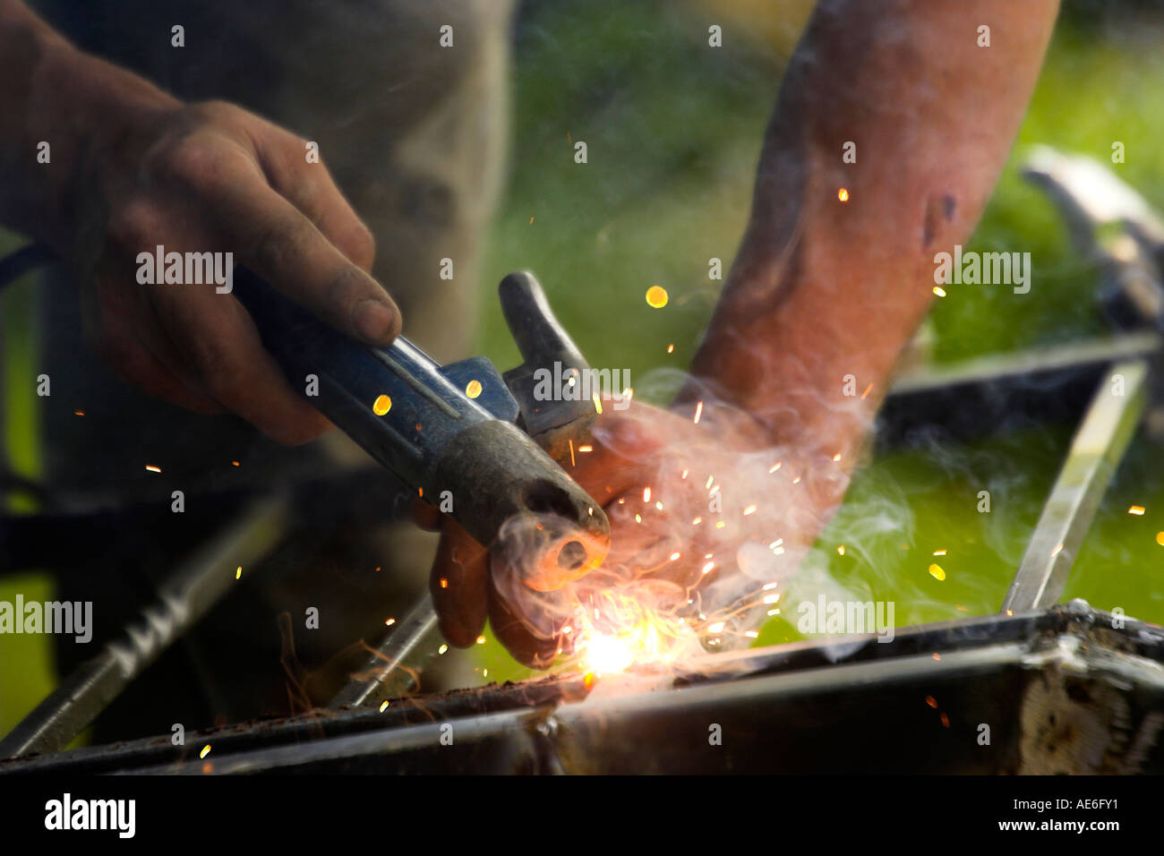 blacksmith welding wrought iron work Stock Photo - Alamy