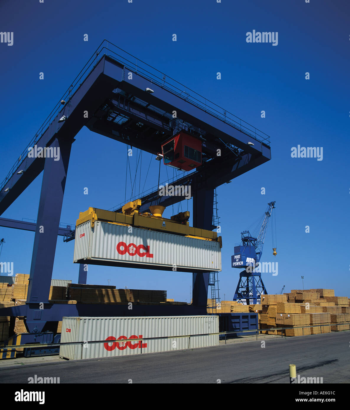 Cranes and container handling gantry with stacks of cut timber Port of ...