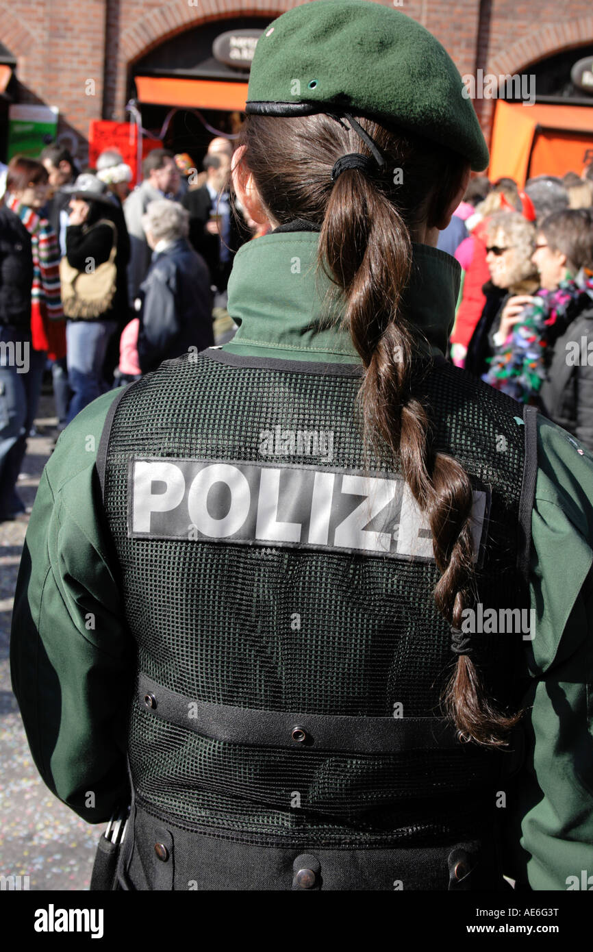 female Police officer watching the Fasching in Munich at ...