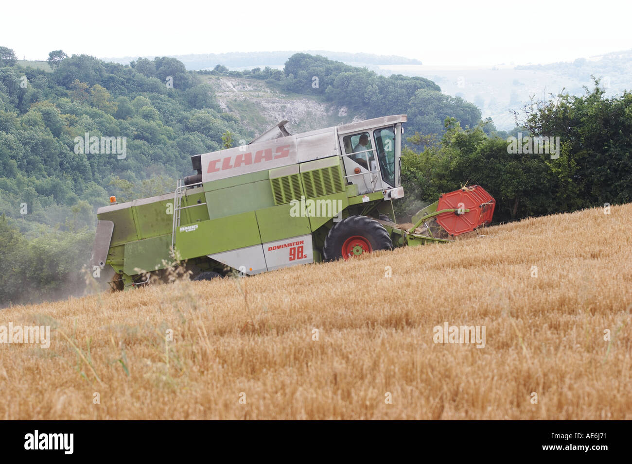 Combine Harvester combining Barley in a field nr Amberly West Sussex ...