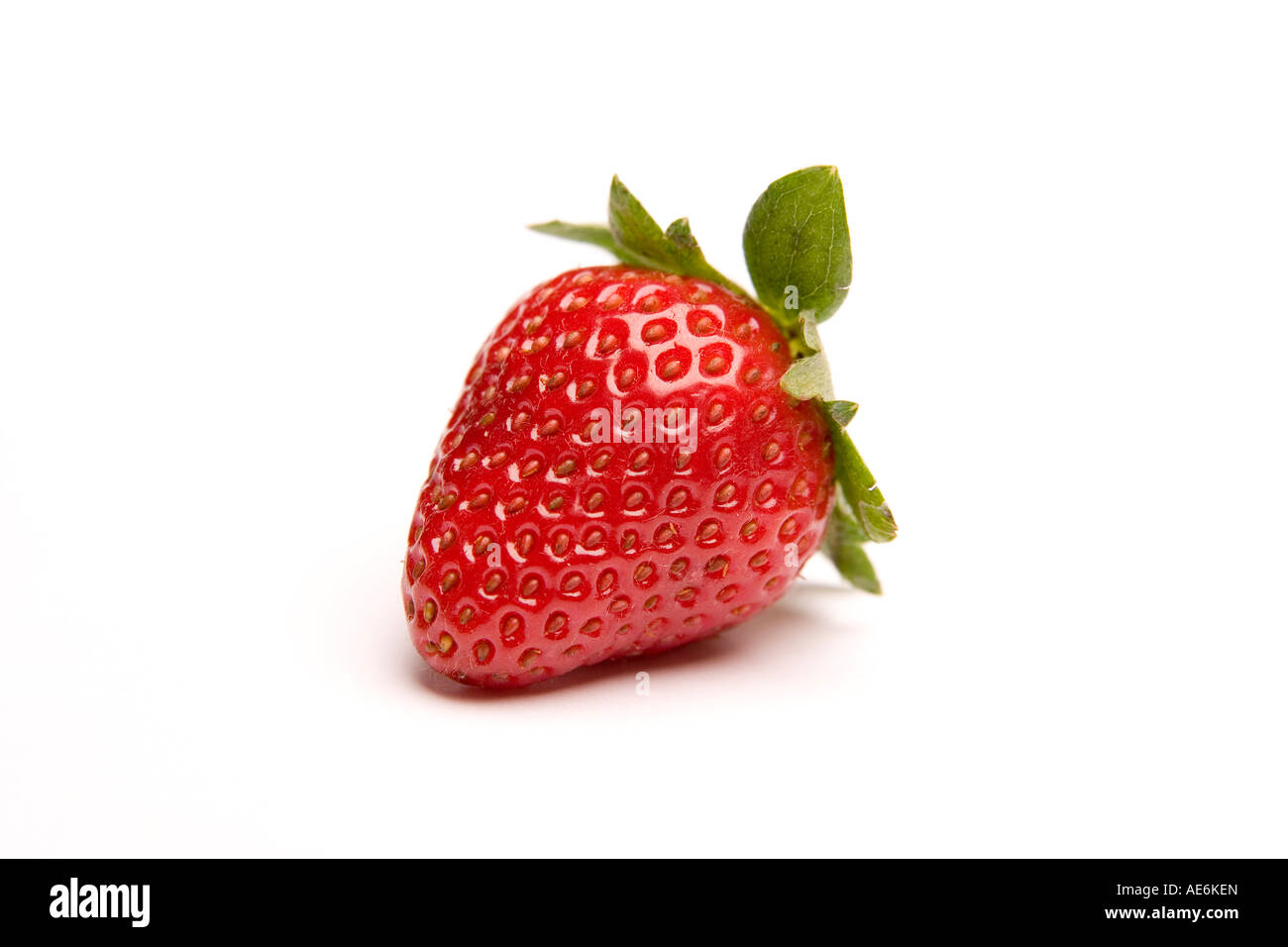 Single strawberry on a white background Stock Photo - Alamy