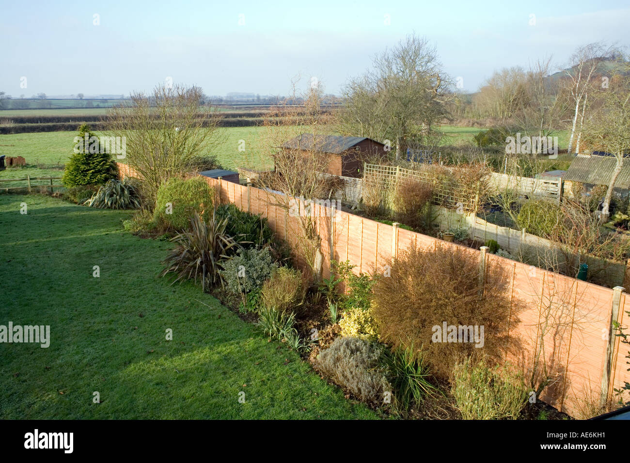 Back gardens in winter West Chinnock Somerset Back rear garden lawn ...
