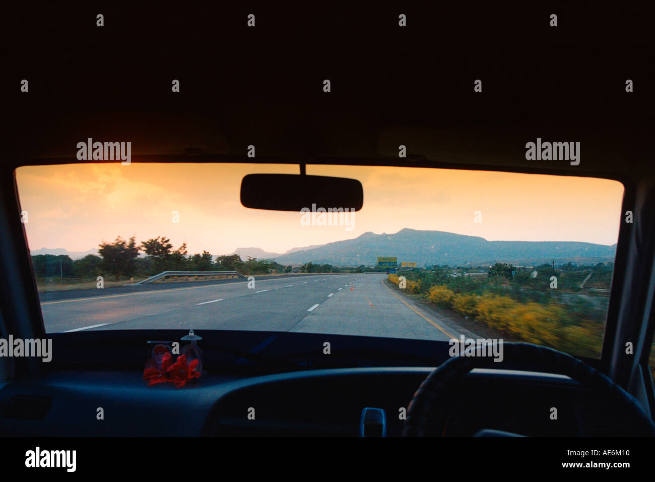 RHS71005 View from inside a car showing landscape road rear view mirror ...