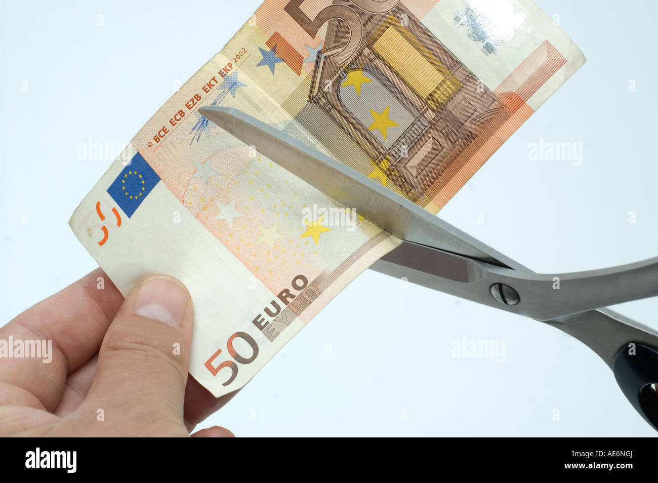 a banknote cutting by scissors Stock Photo - Alamy