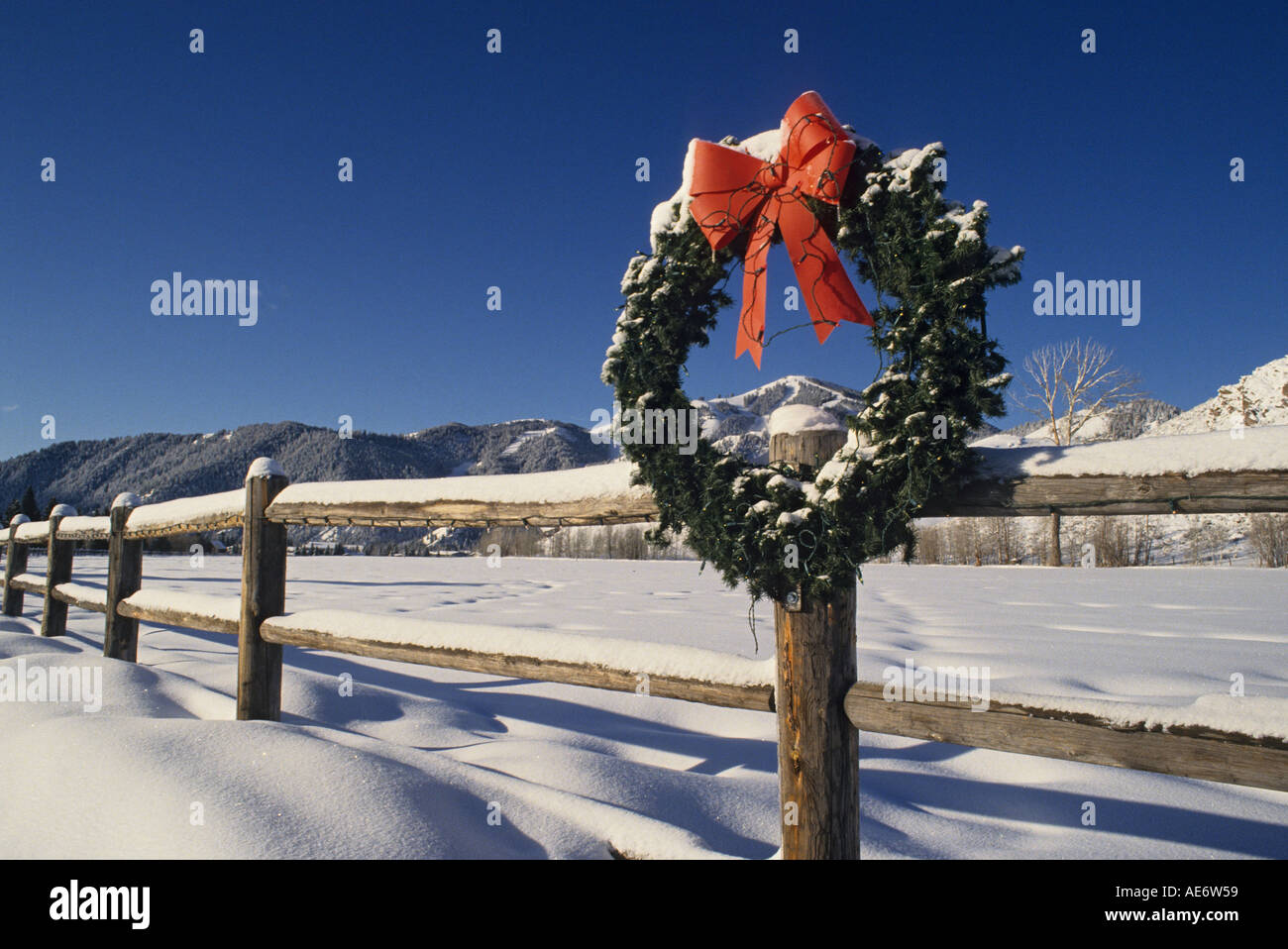 Idaho Sun Valley Christmas wreath on wood fence view toward snow ...
