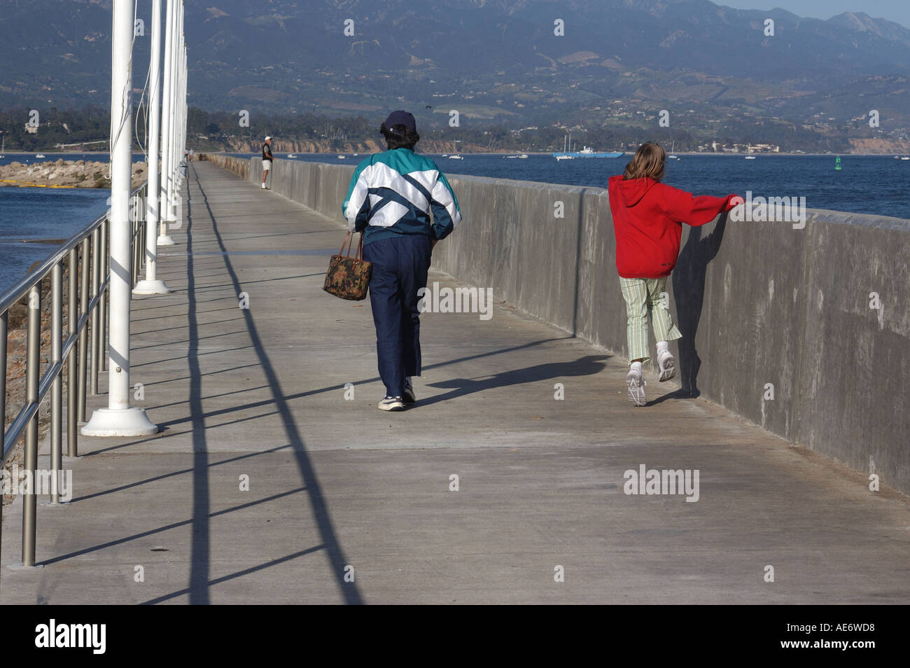 People Walking Breakwall Stock Photo - Alamy