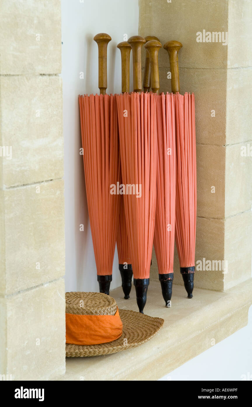Colourful parasols and straw hat on window ledge Stock Photo - Alamy