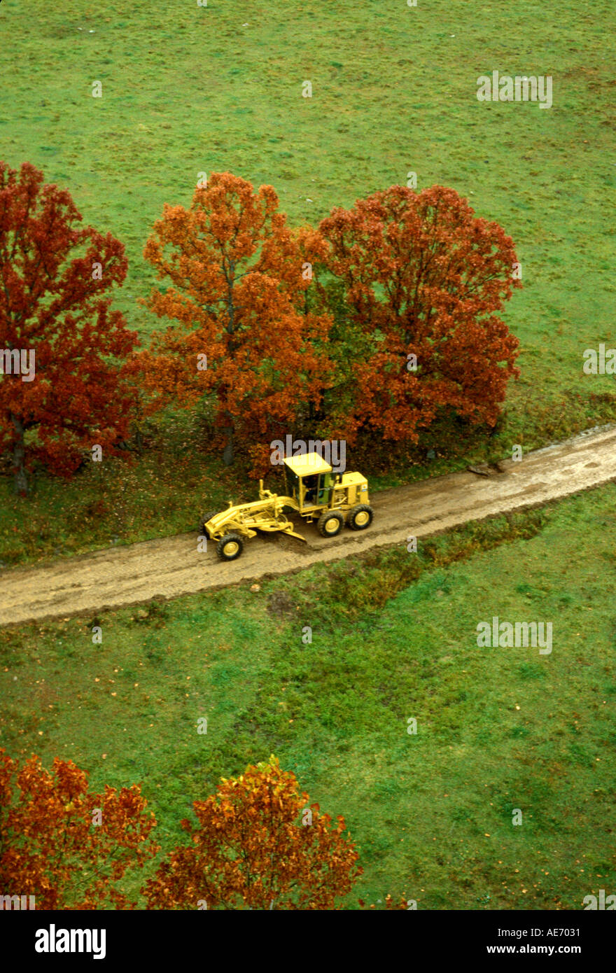 Caterpillar road grater smoothing rural road Stock Photo - Alamy