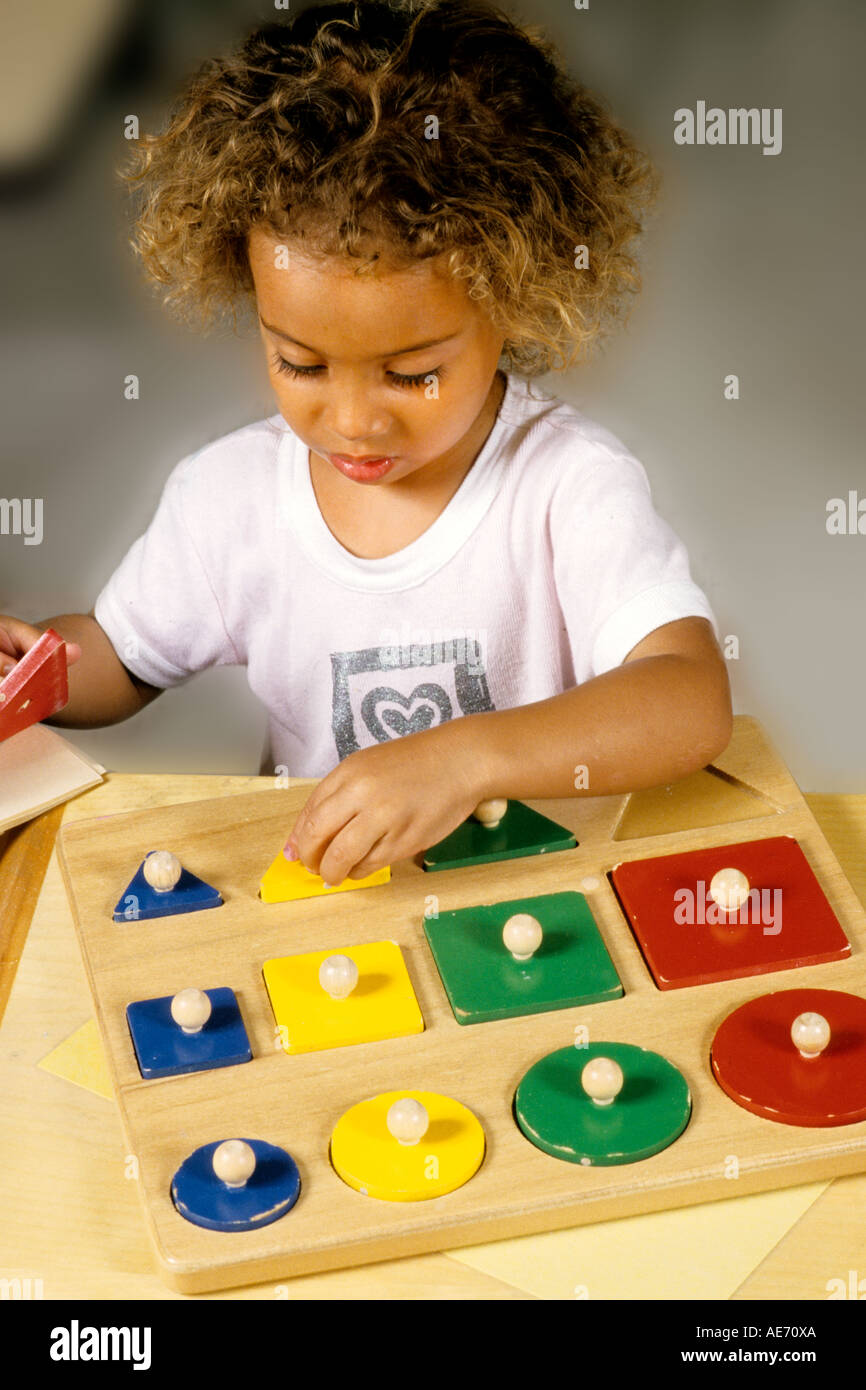Young girl age 5 practicing with blocks to learn shapes in school Stock Photo - Alamy