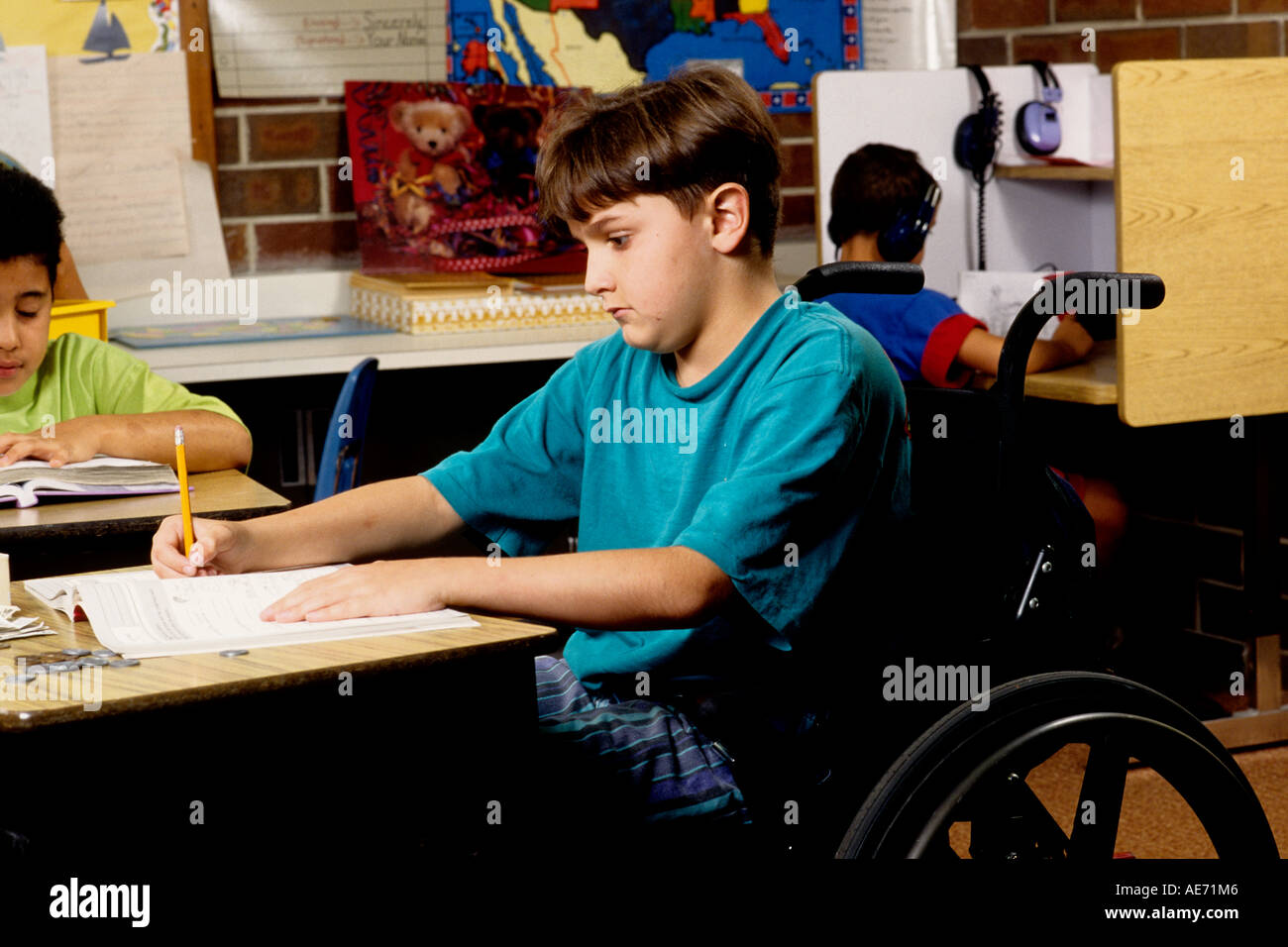 Handicapped student with energetic smile age 10 in grade 5 at desk ...