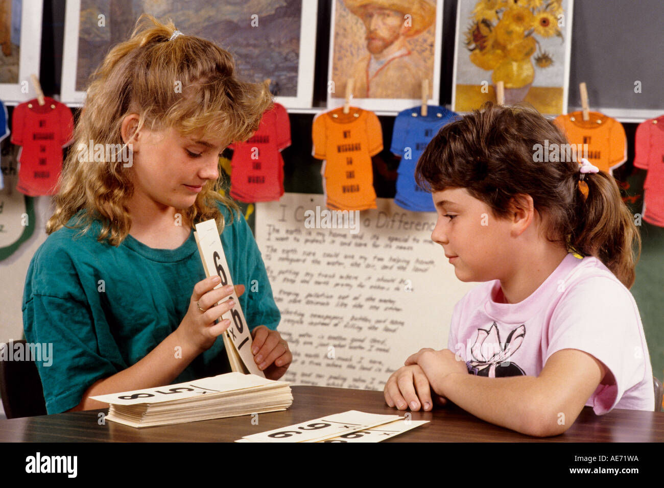 Student helping another 3rd grade student learn math with flash cards ...