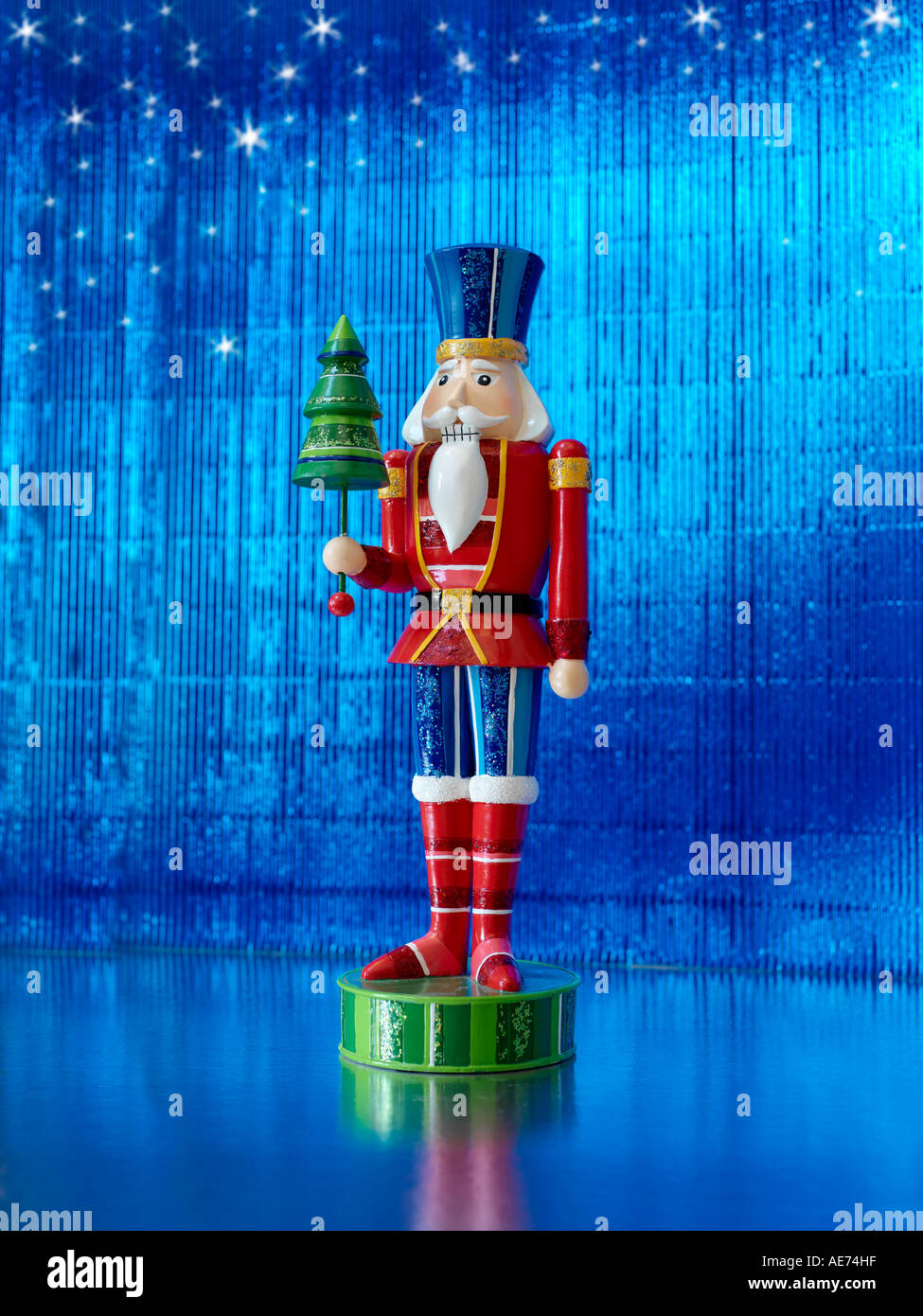 Festive toy soldier from toy town holding a Christmas tree in his hand ...