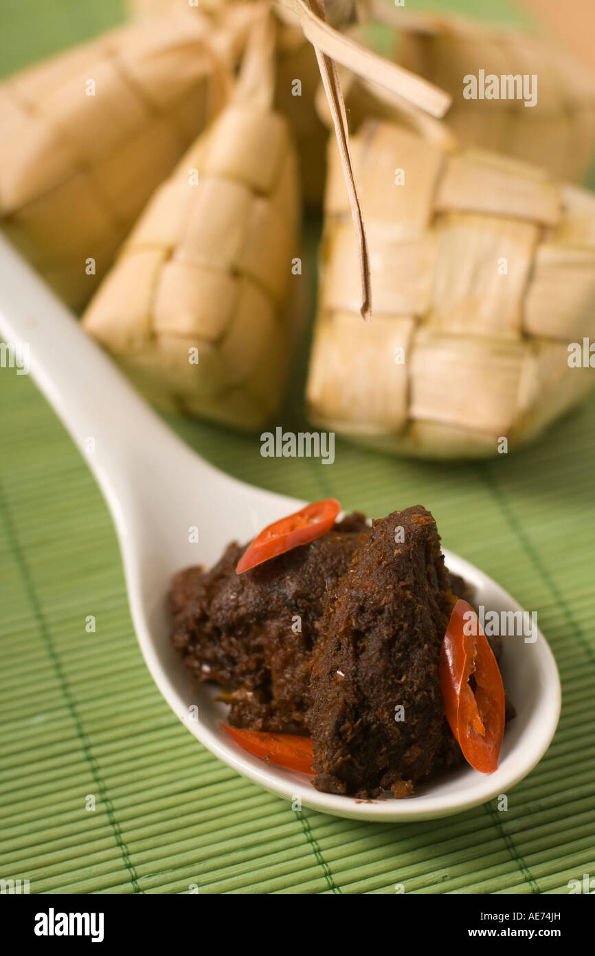Rendang Malay beef curry with ketupat glutinous rice cakes wrapped in ...