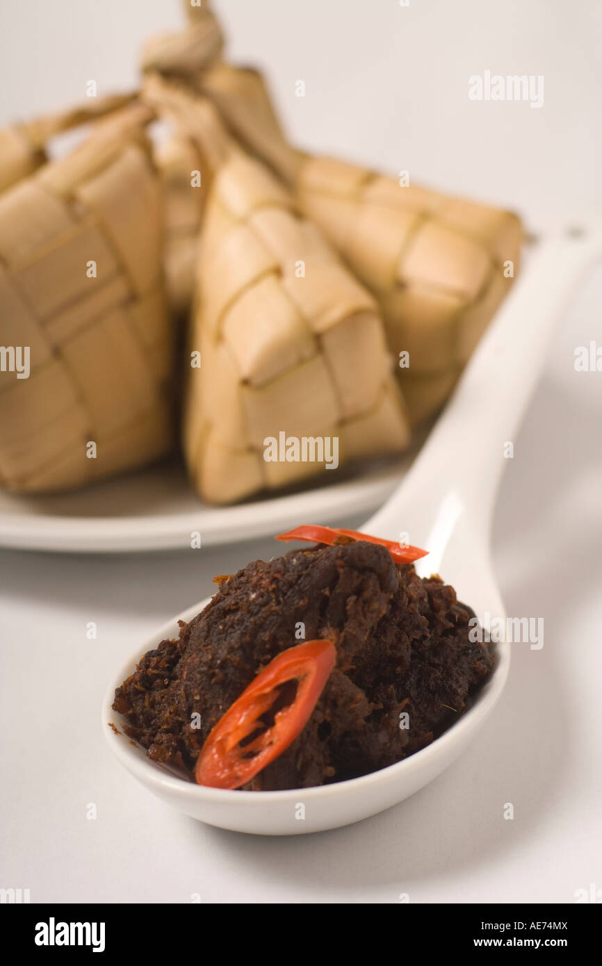Rendang Malay beef curry with ketupat glutinous rice cakes wrapped in ...