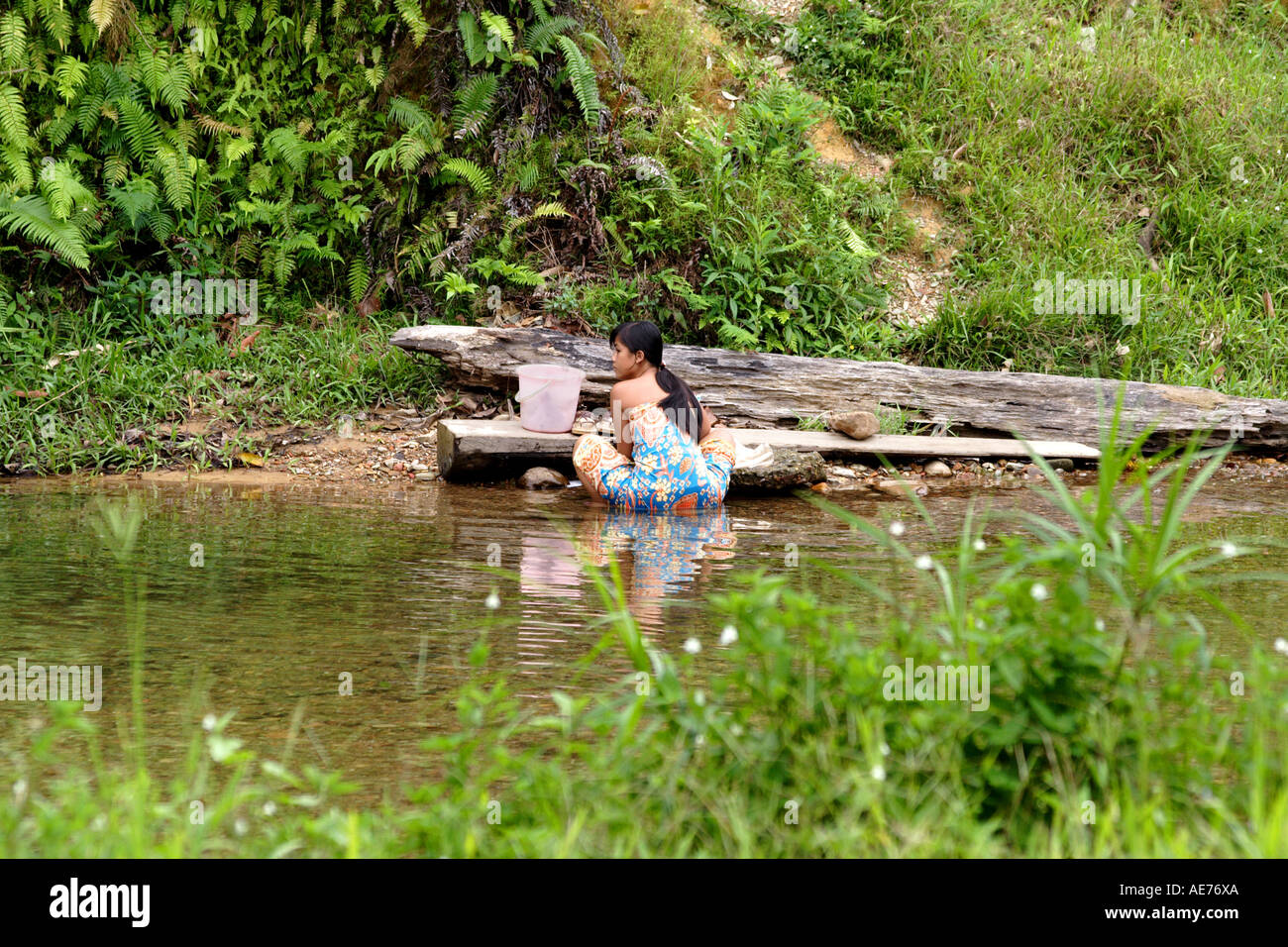 Beautiful Young Malaysian Woman Washing Clothes in the River at Rumah ...