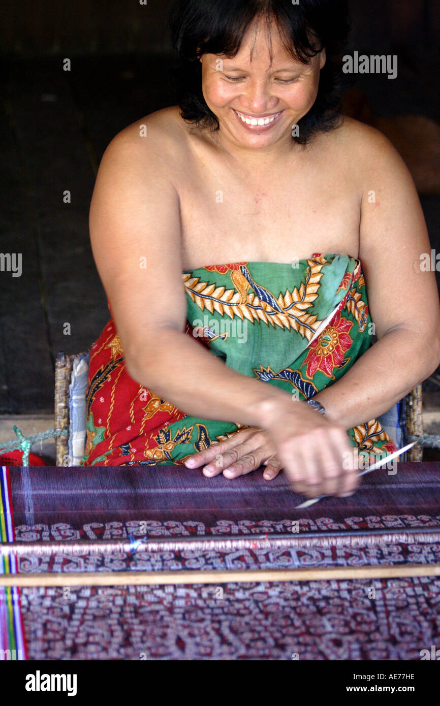 Woman Hand Weaving Ceremonial Fabric on Loom on Shared Porch, Rumah ...
