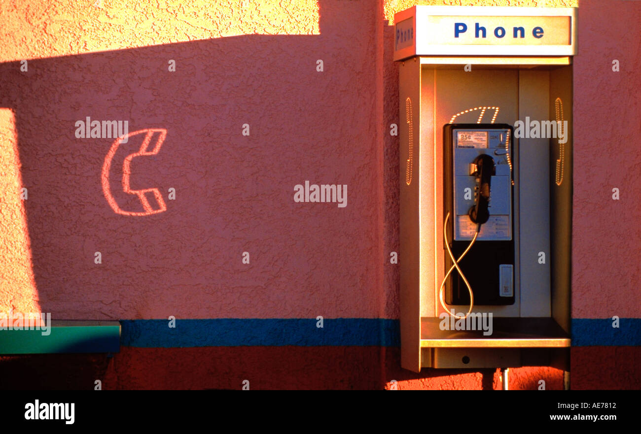 Outdoor pay phone with shadow of receiver on wall Stock Photo - Alamy
