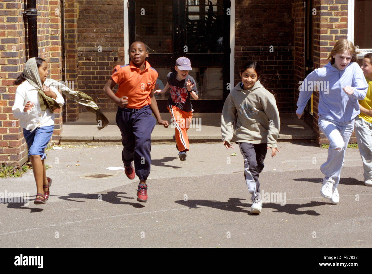 Primary school children 8 to 10 year old running in playground Stock ...