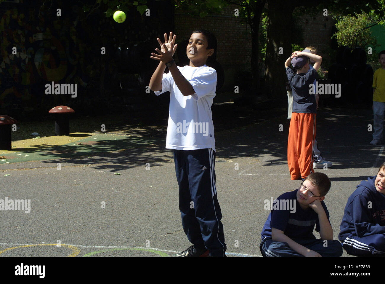 Primary school child catching ball Stock Photo - Alamy