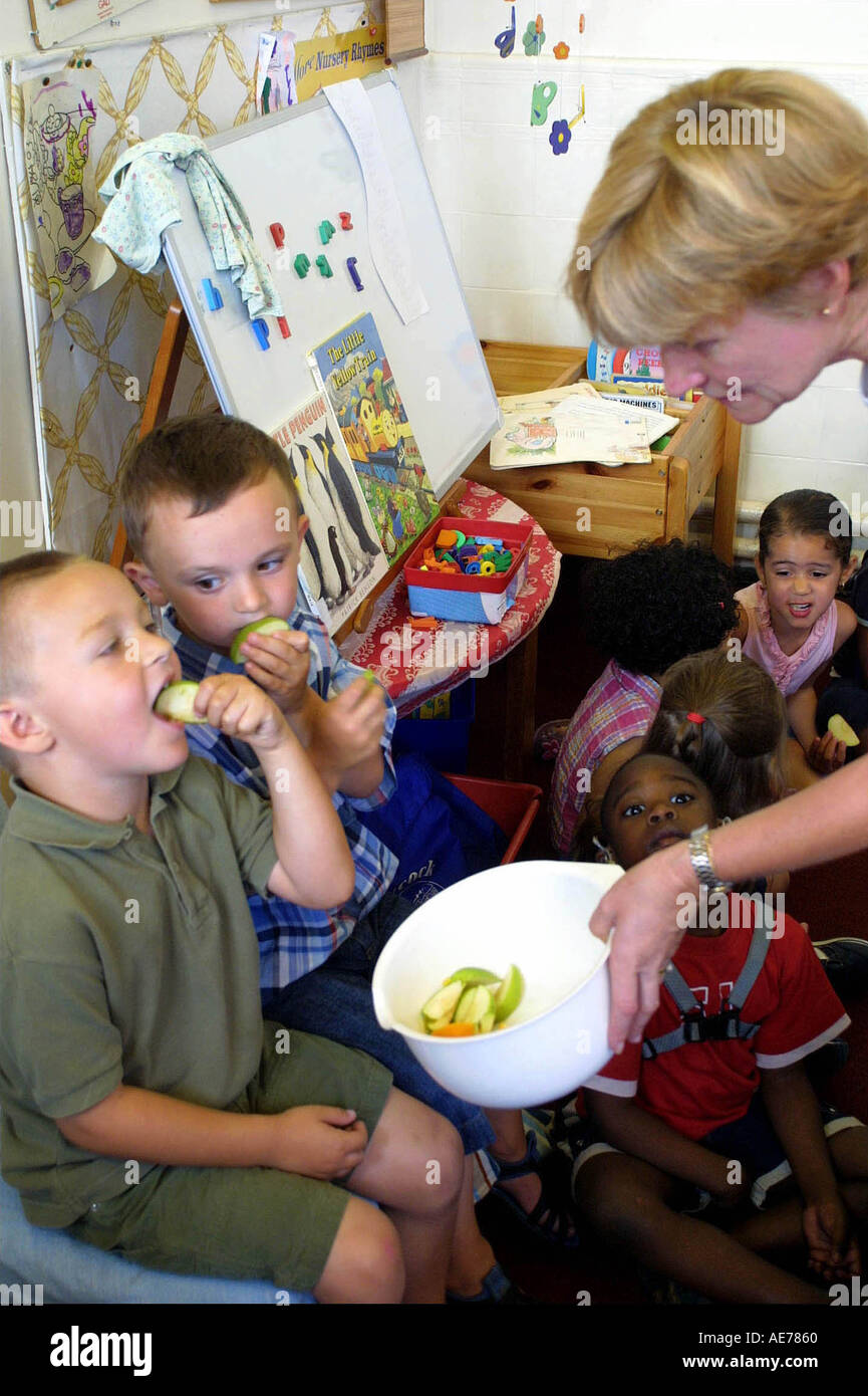Nursery school children eating fruit Stock Photo - Alamy
