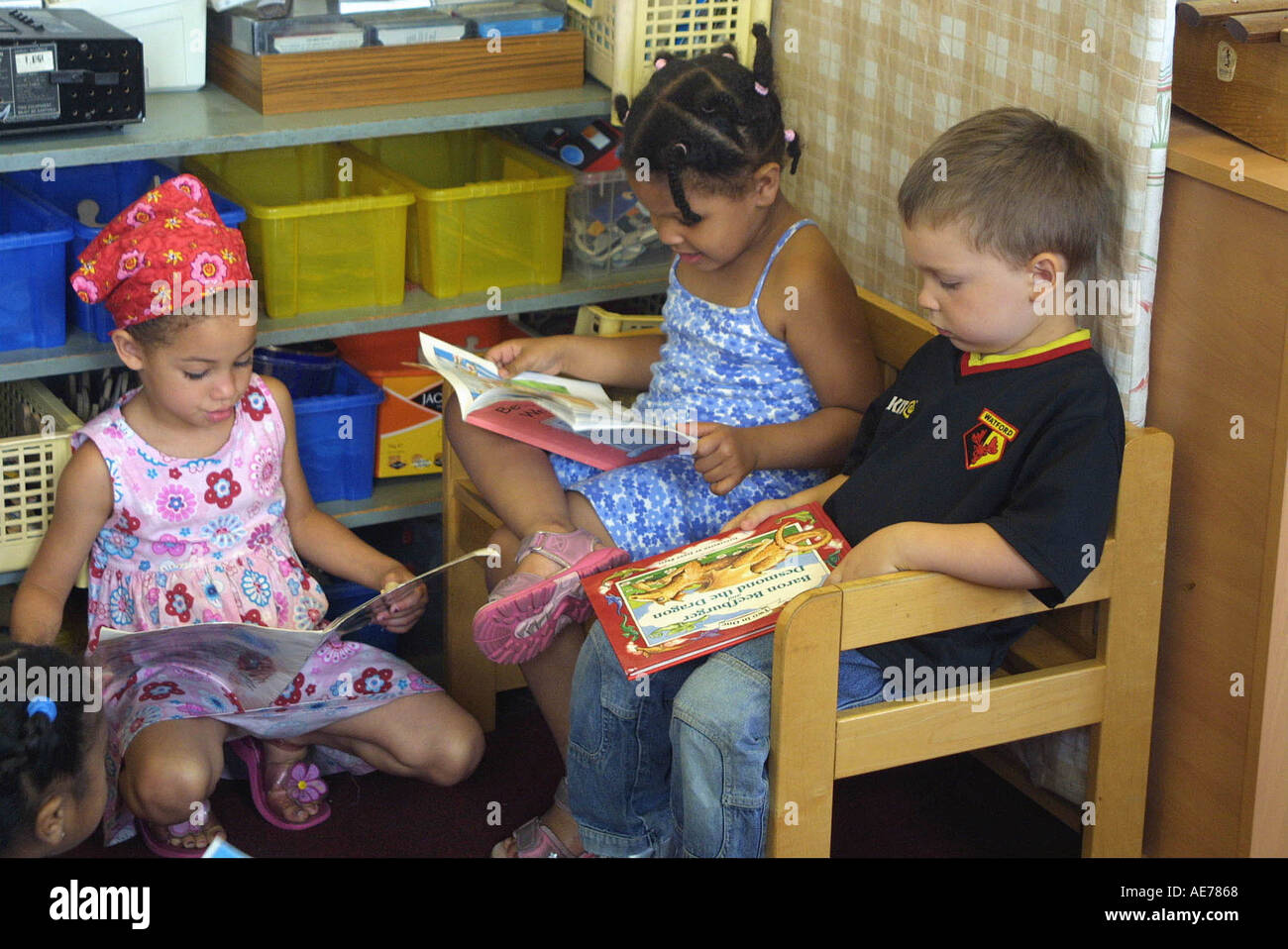 kids reading books in nursery school Stock Photo - Alamy