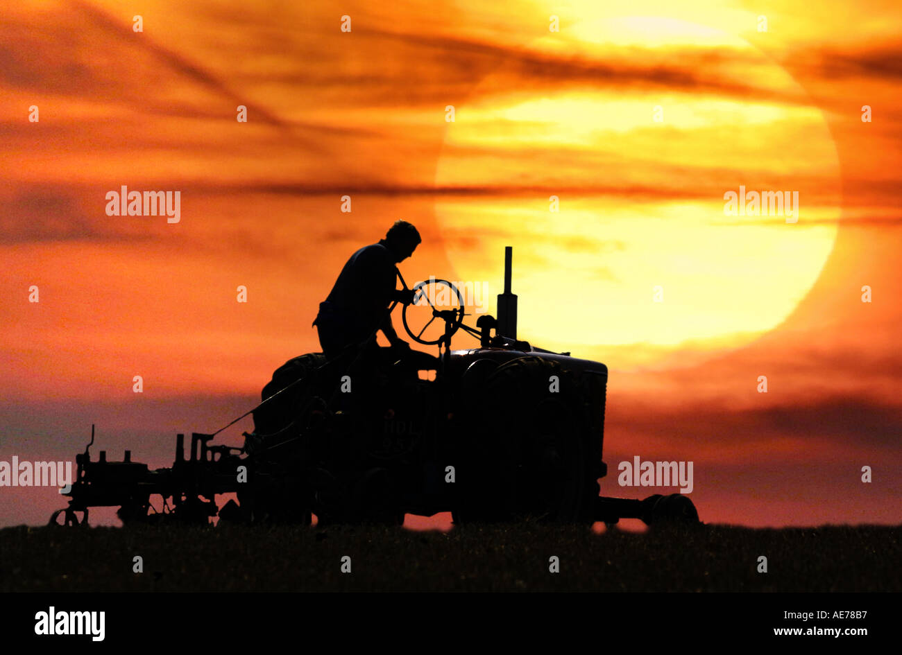 Classic old Tractor ploughing at sunset Isle of Wight Engalnd UK Stock ...