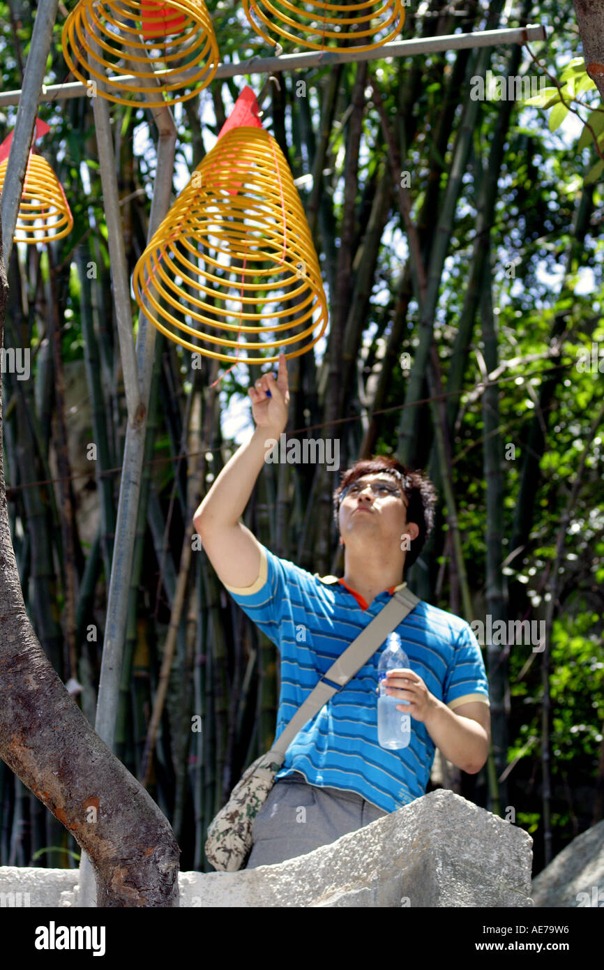 Korean Tourist Touching Coiled Incense Sticks at the A-Ma Temple or Tin ...
