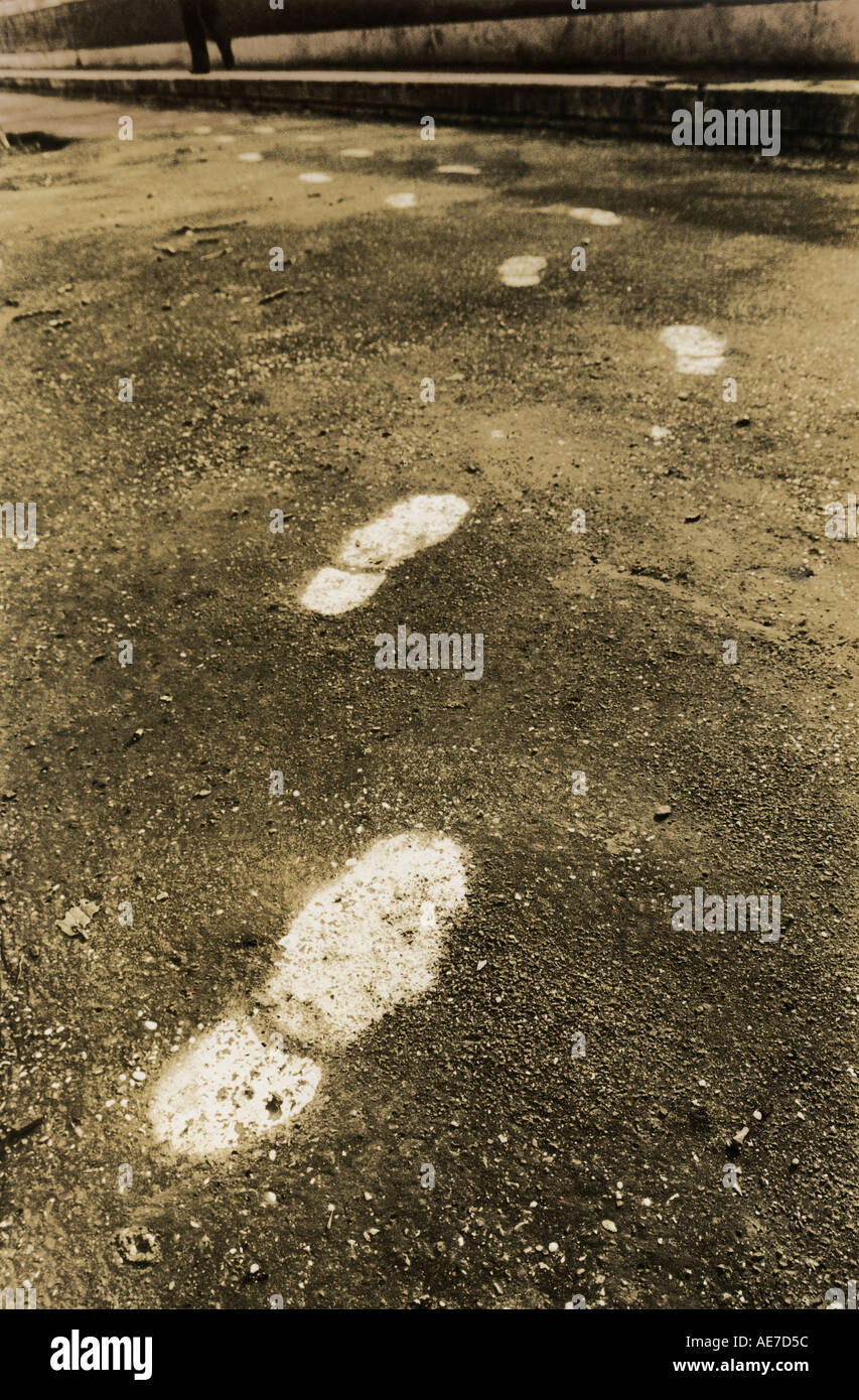 footprints on a road Stock Photo - Alamy