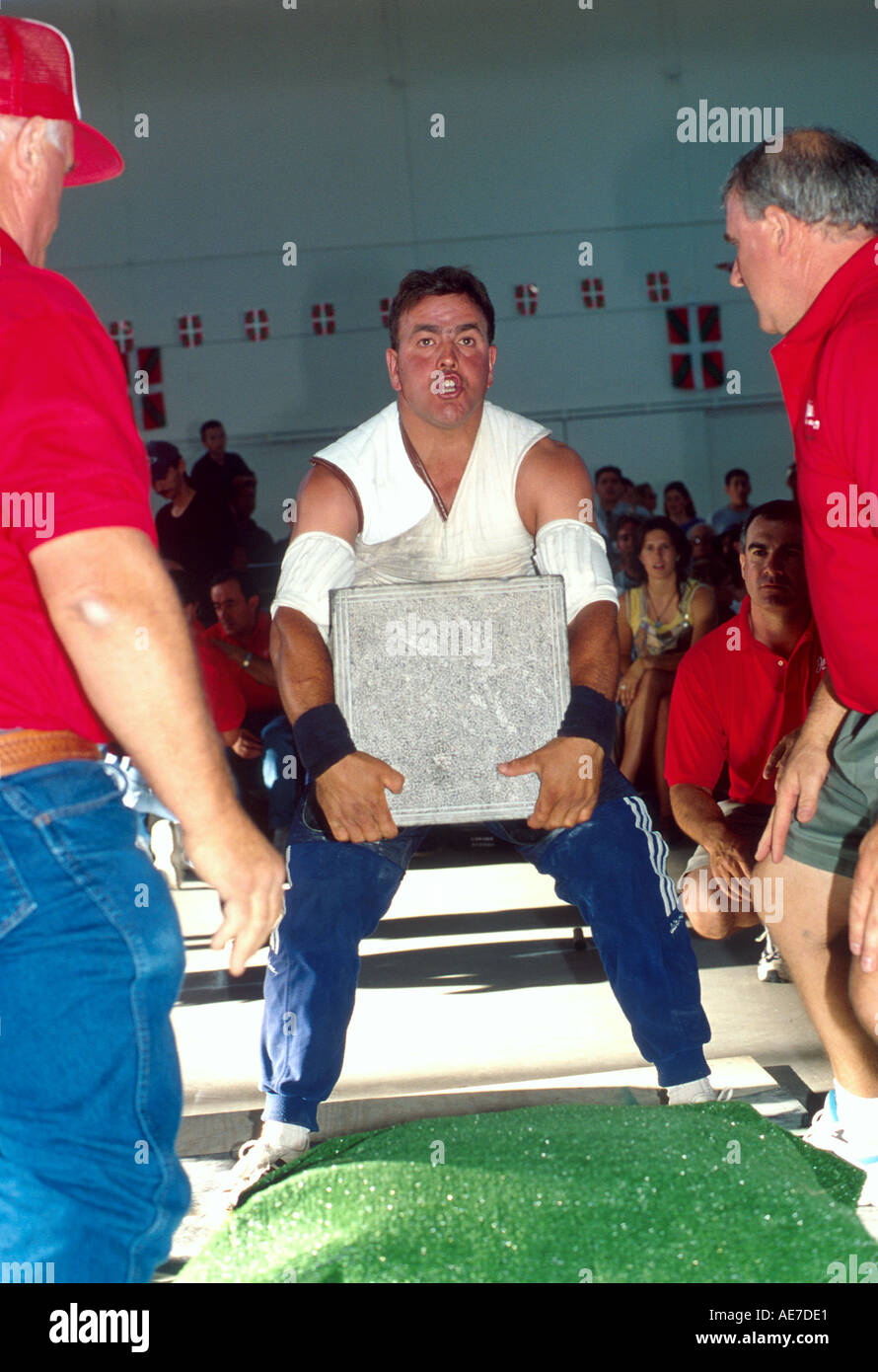 Man lifting a slab of rock in a weightlifting event at a Basque ...