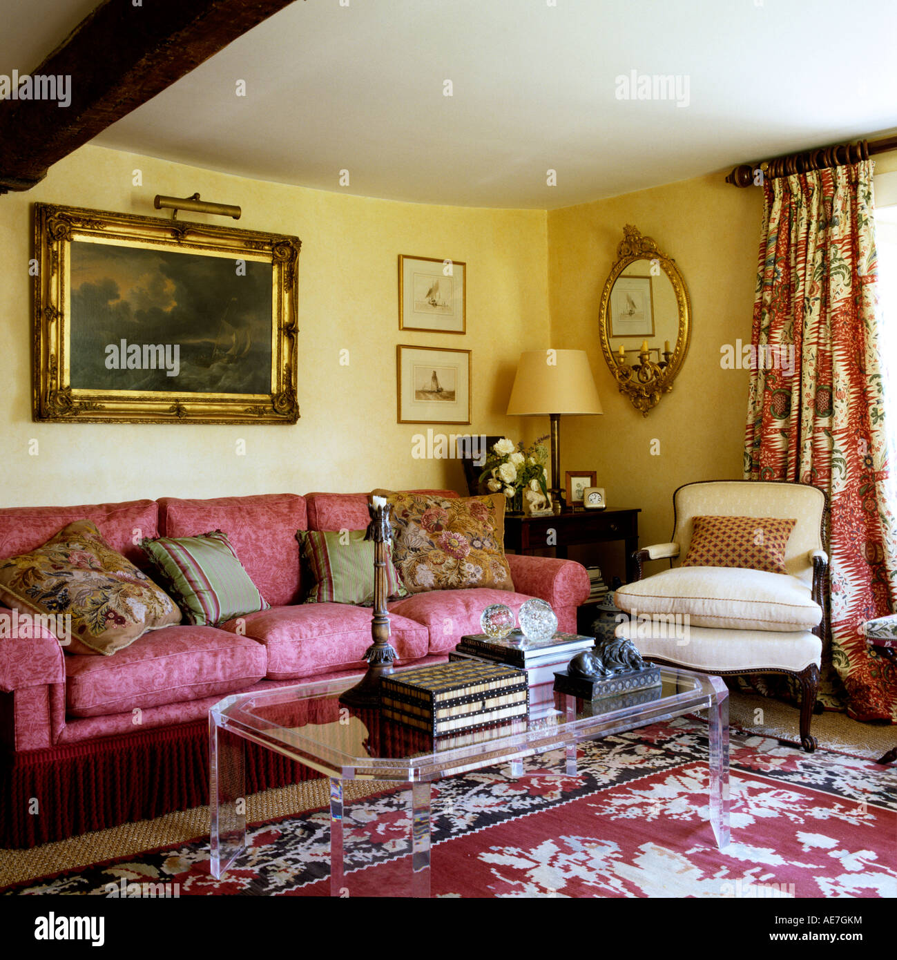 Sofa and armchair on patterned rug in traditionally British sitting ...