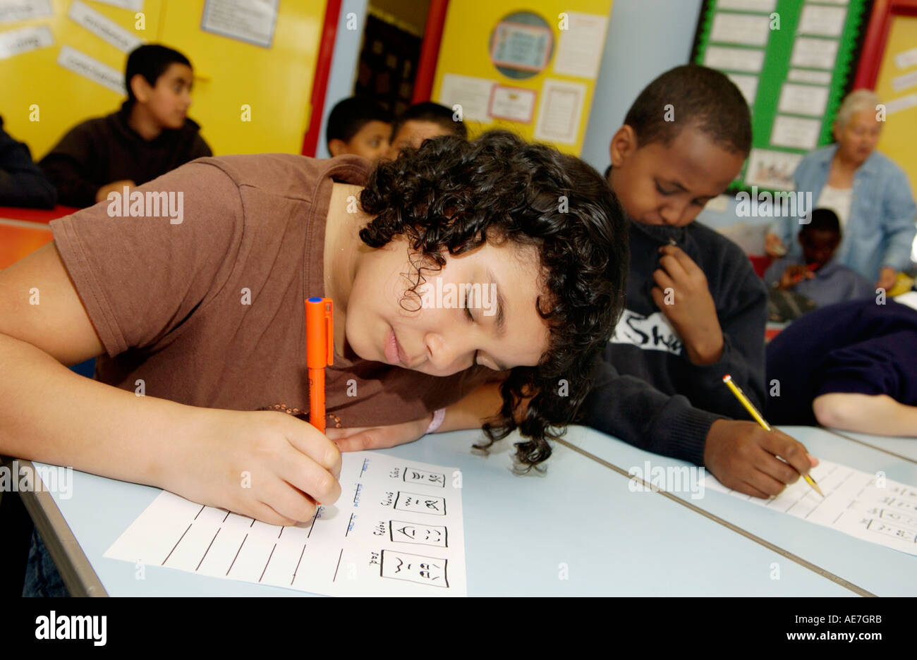 Pupils in creative writing workshop taking place in classroom of a ...