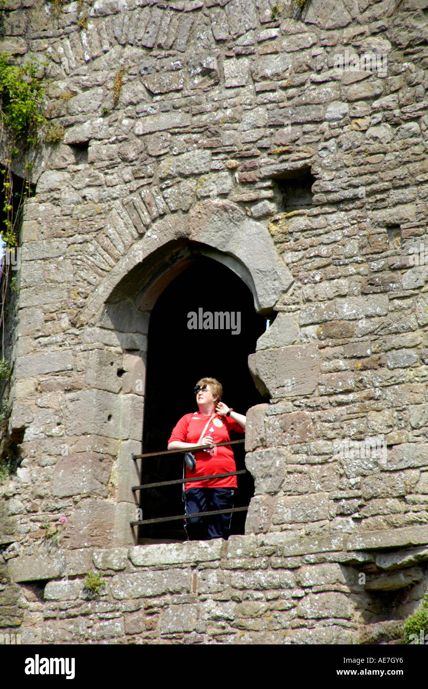 Visitor looking out of window in The Great Tower of Raglan Castle ...