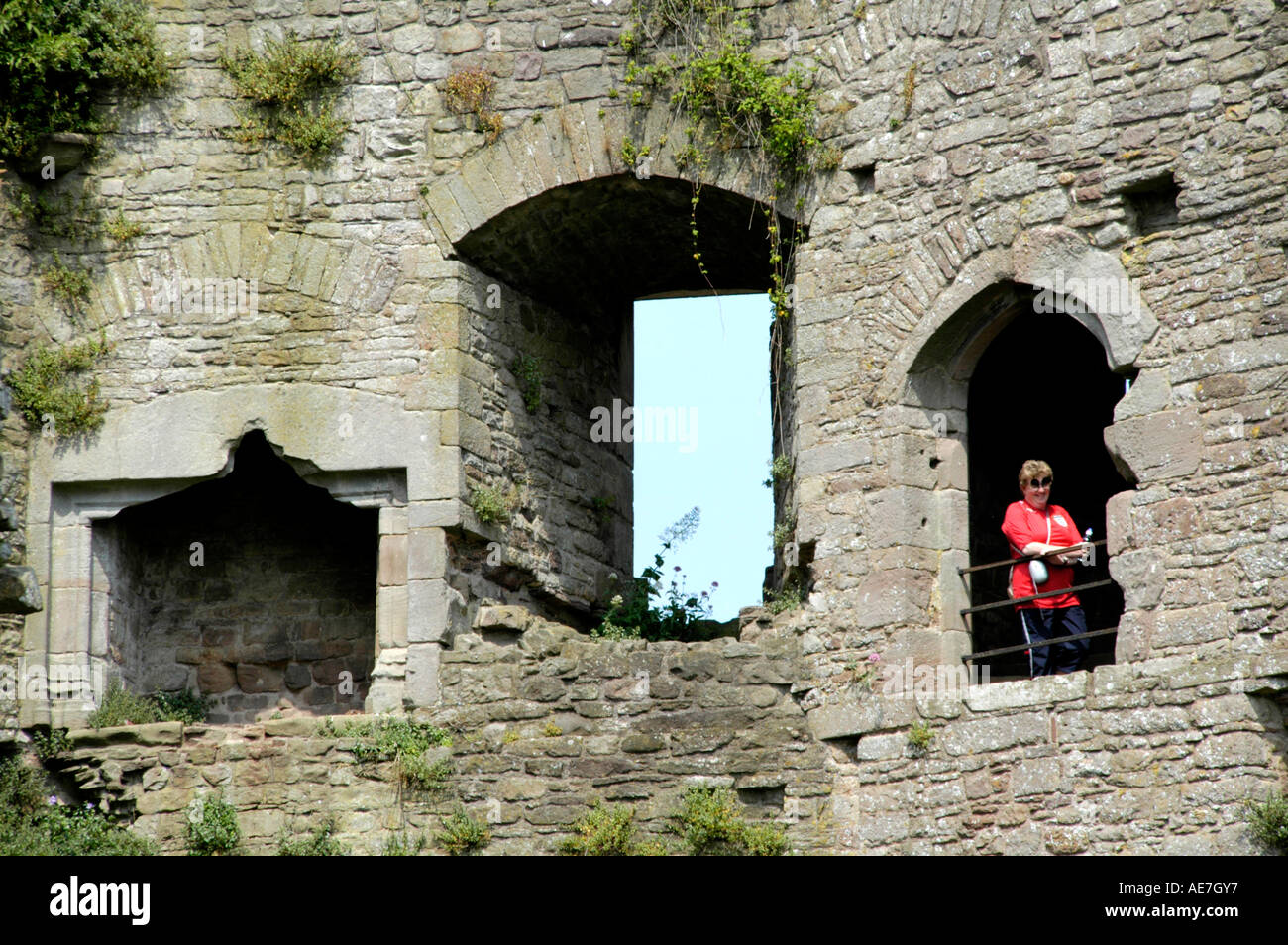 Visitor looking out of window in The Great Tower of Raglan Castle ...