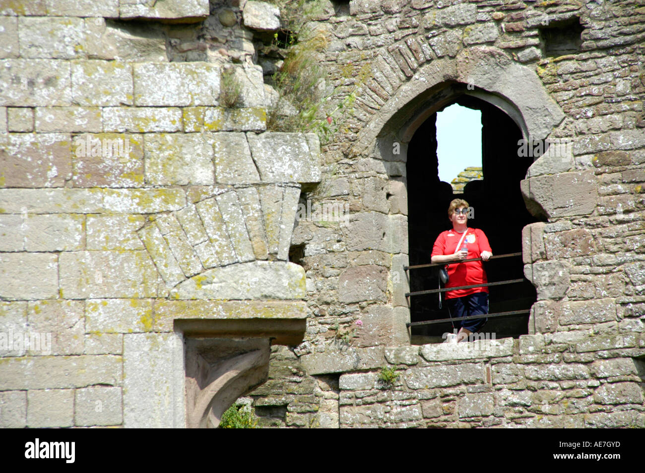 Visitor looking out of window in The Great Tower of Raglan Castle ...