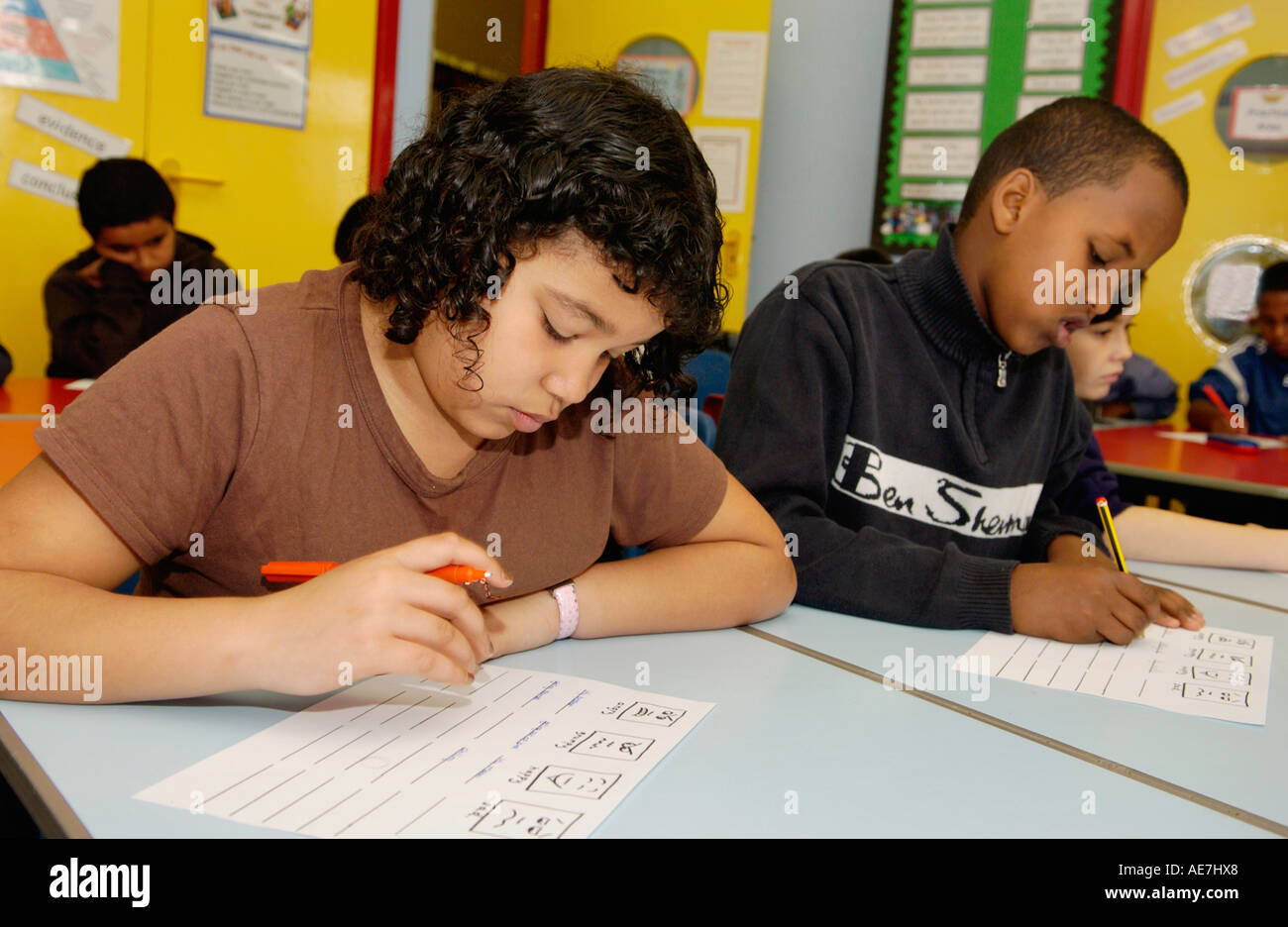 Pupils in creative writing workshop taking place in classroom of a ...