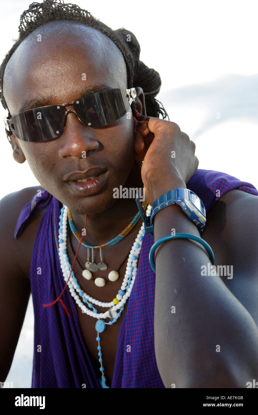 modern masai warrior relaxing on the beach in Zanzibar Stock Photo - Alamy
