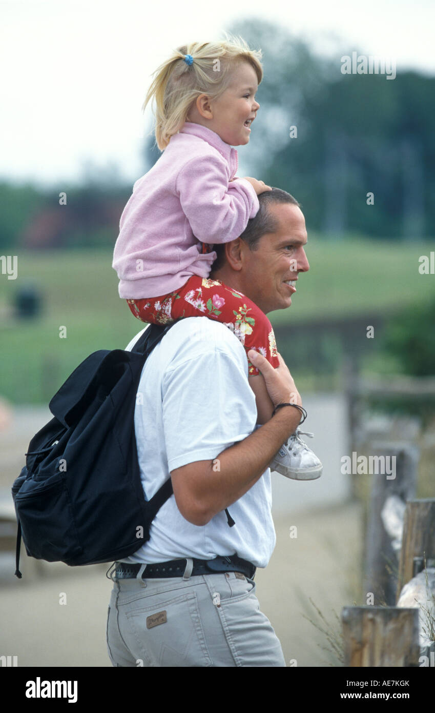Father is carrying a child on his shoulders Stock Photo - Alamy