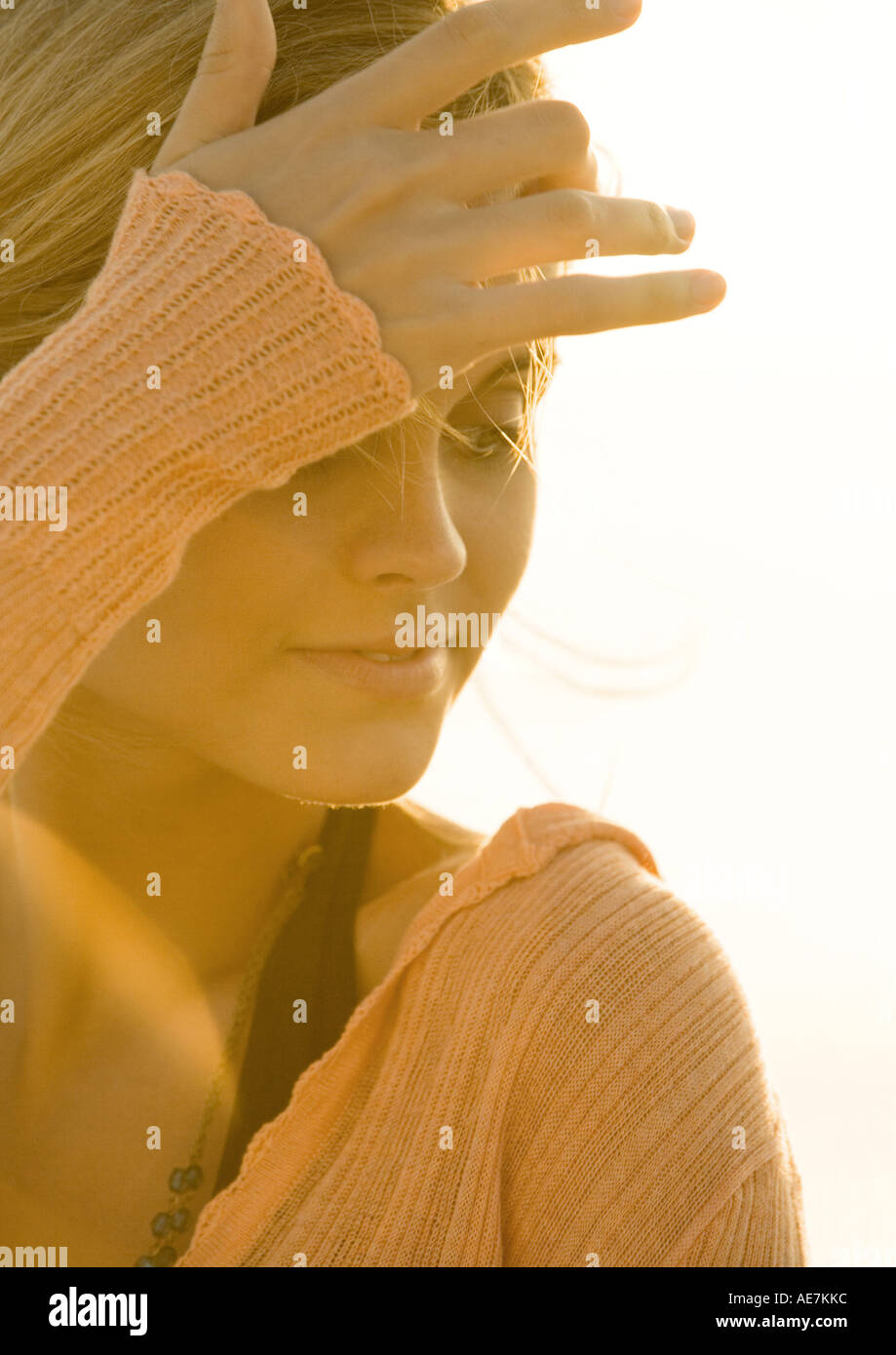 Woman pushing hair out of eyes Stock Photo - Alamy