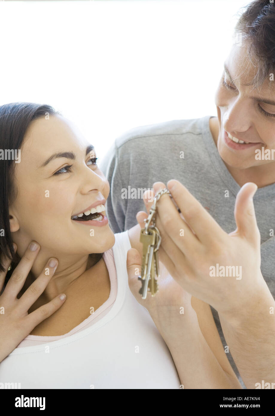 Man handing woman keys, woman smiling Stock Photo - Alamy