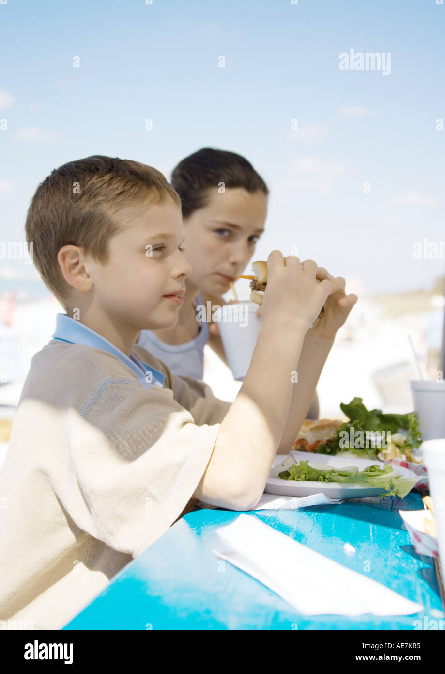 Kids eating outdoors Stock Photo - Alamy