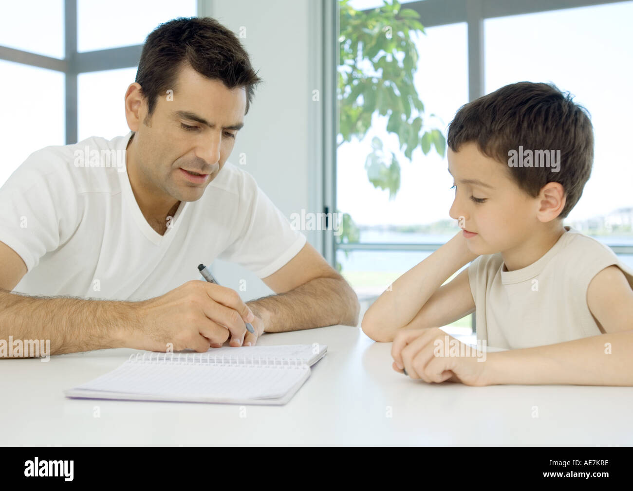 Man helping son with homework Stock Photo - Alamy