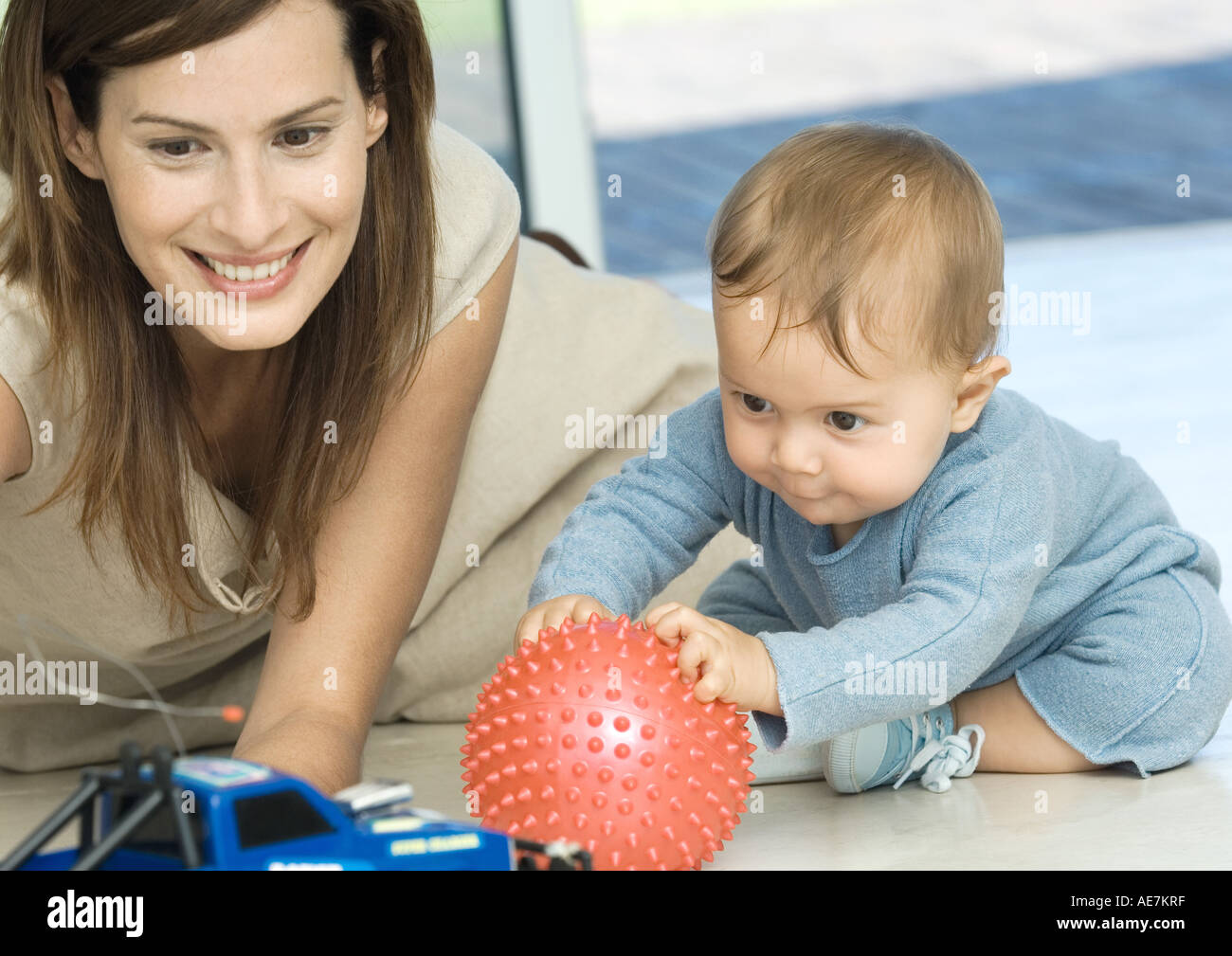 Three mothers playing with their babies hi-res stock photography and ...