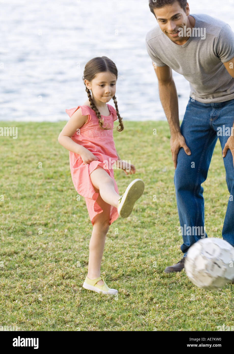Man playing soccer with daughter Stock Photo - Alamy