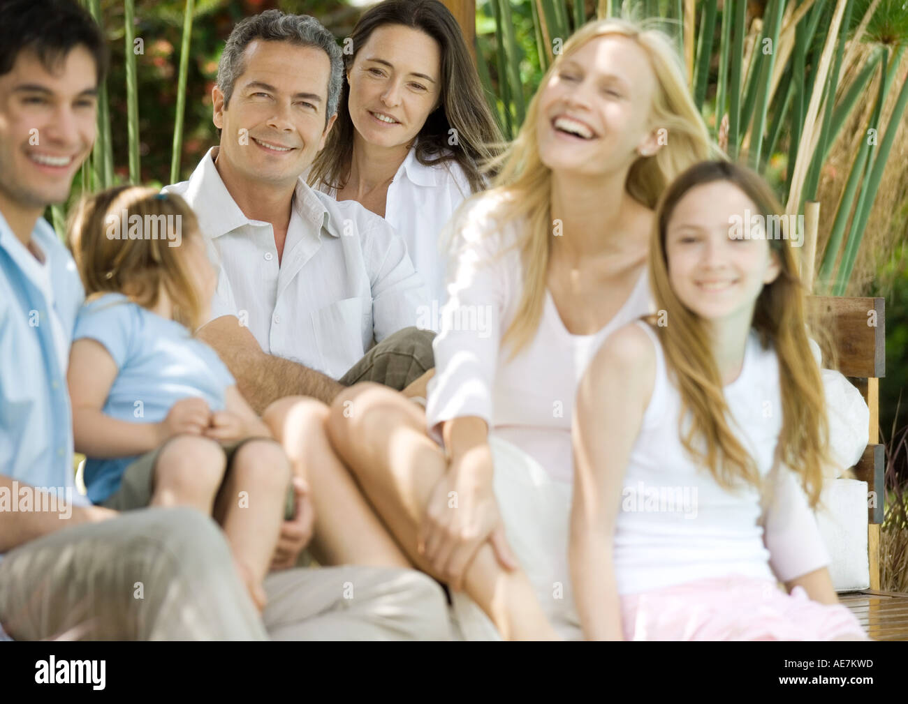 Two couples and two children relaxing together Stock Photo - Alamy