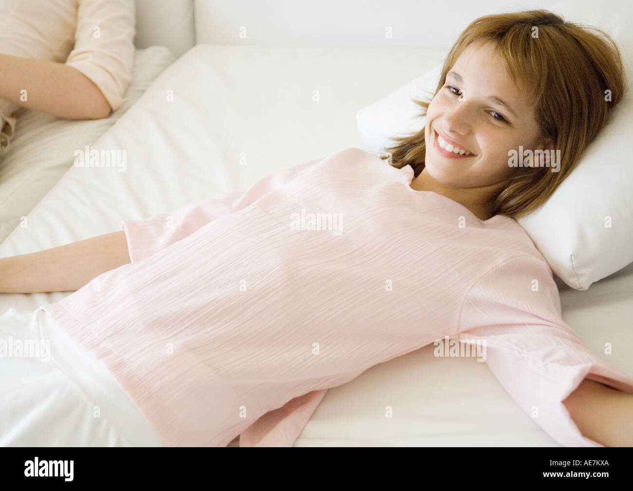 Girl reclining on sofa Stock Photo - Alamy