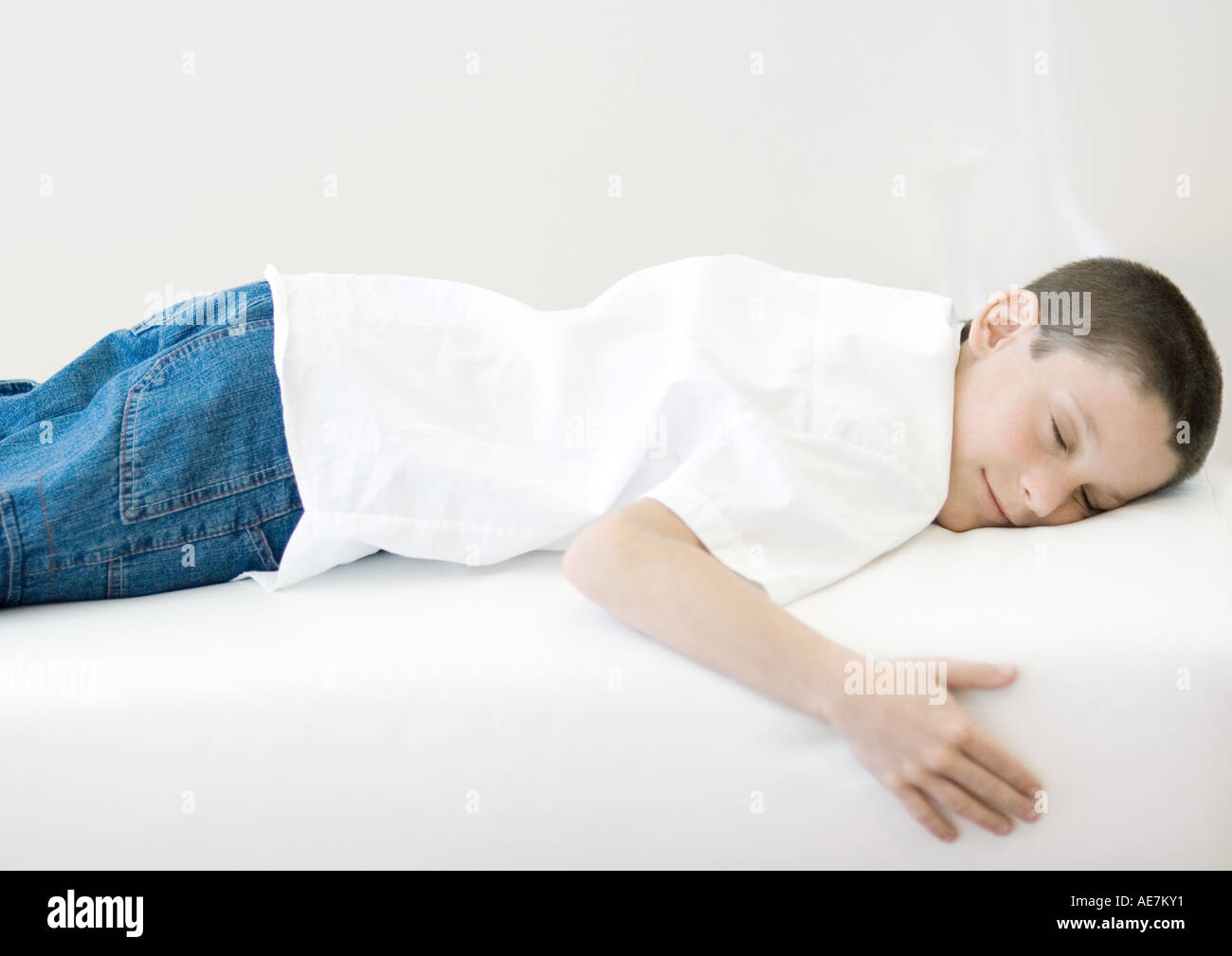 Boy sleeping on sofa Stock Photo - Alamy