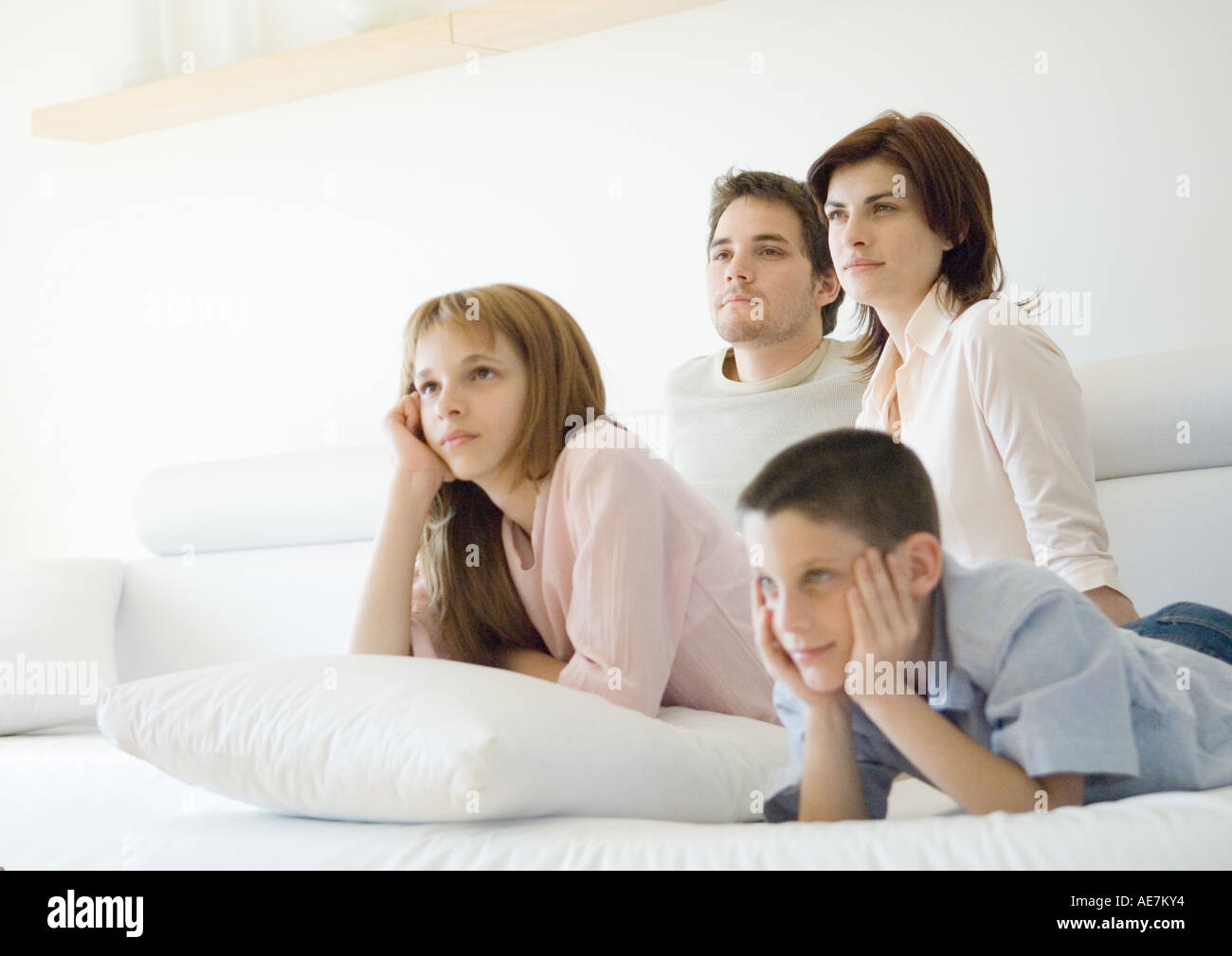 Family watching tv together Stock Photo - Alamy