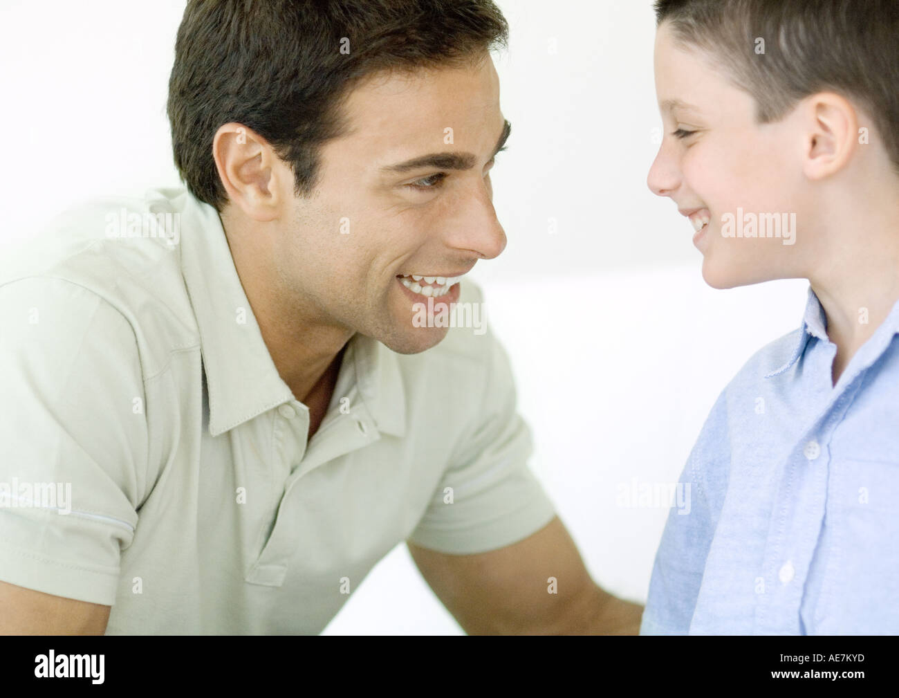 Man and son smiling at each other Stock Photo - Alamy